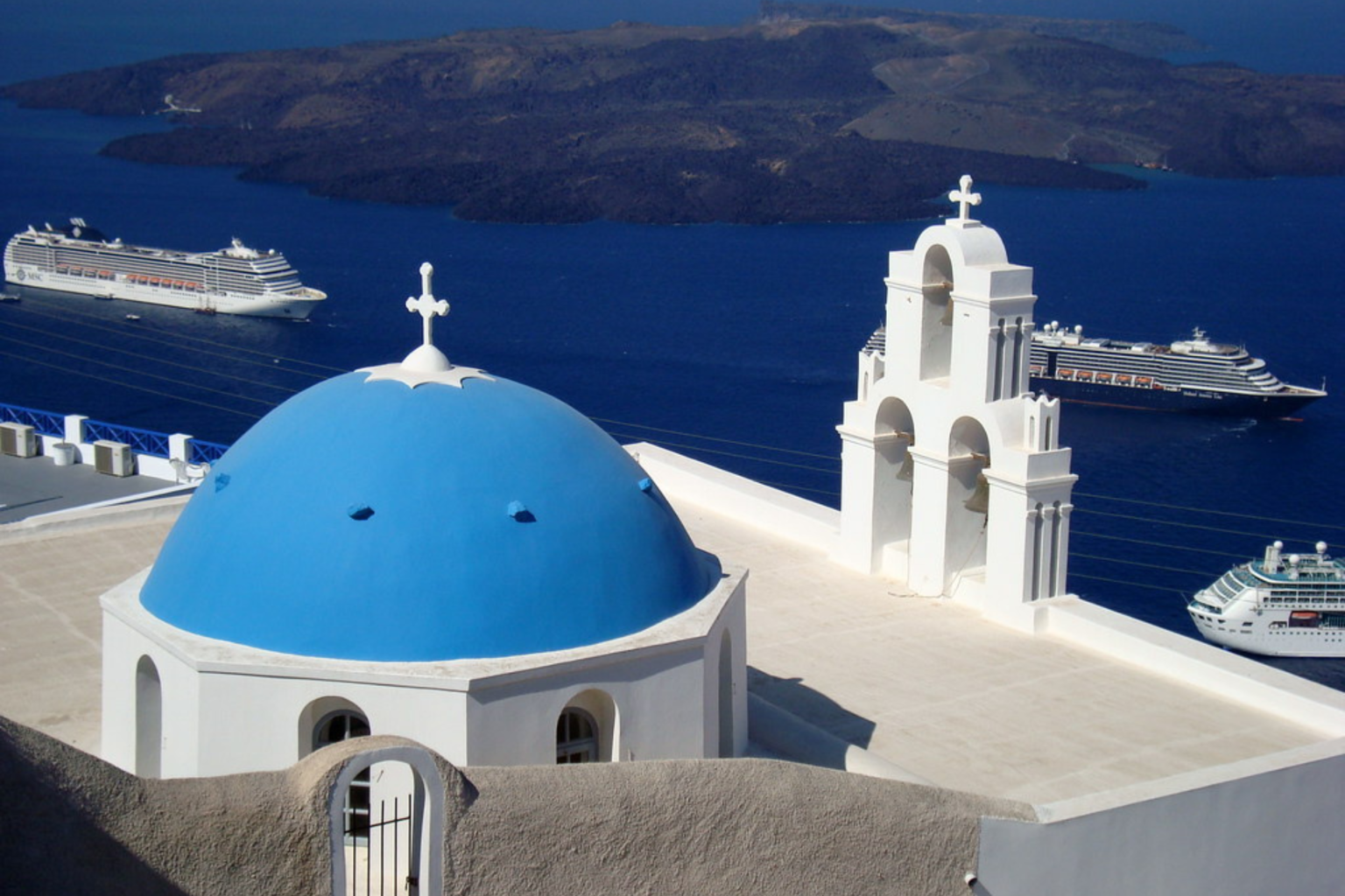 Where to find the famous blue domes of Santorini? - Charisma Suites ...